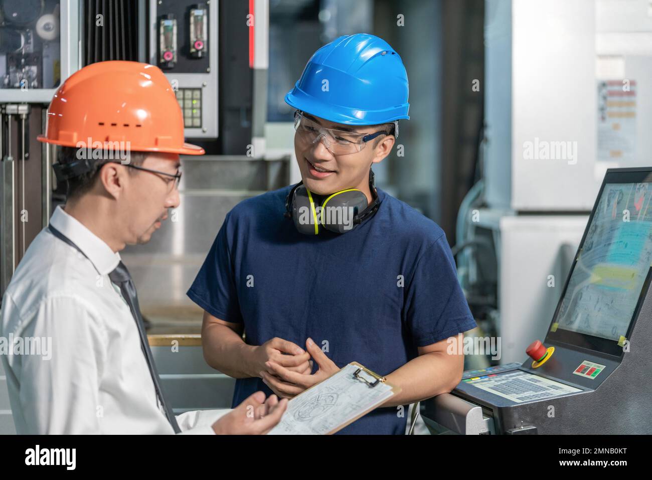 Two engineers working in the factory Stock Photo - Alamy