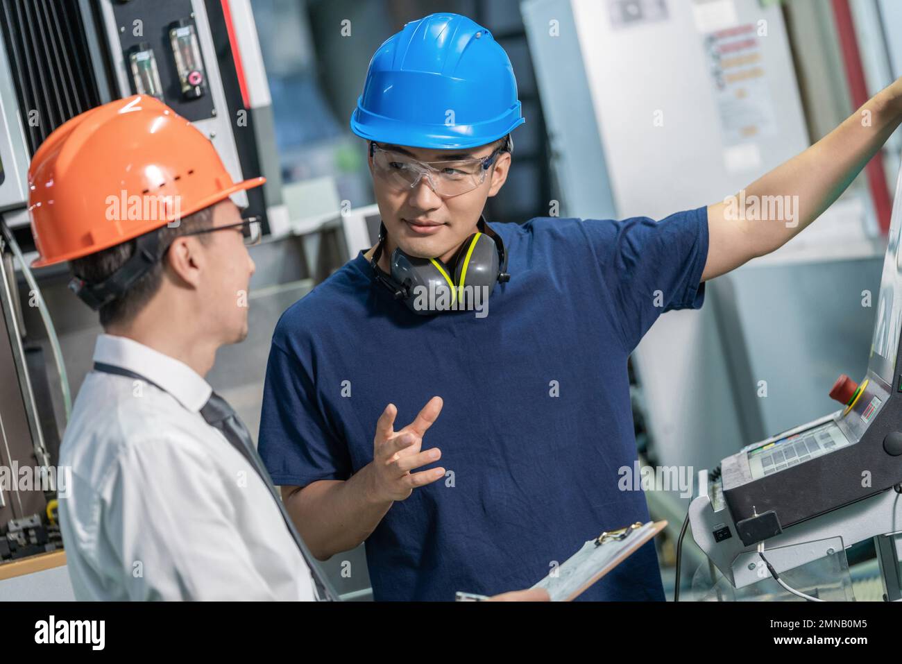 Two engineers working in the factory Stock Photo - Alamy