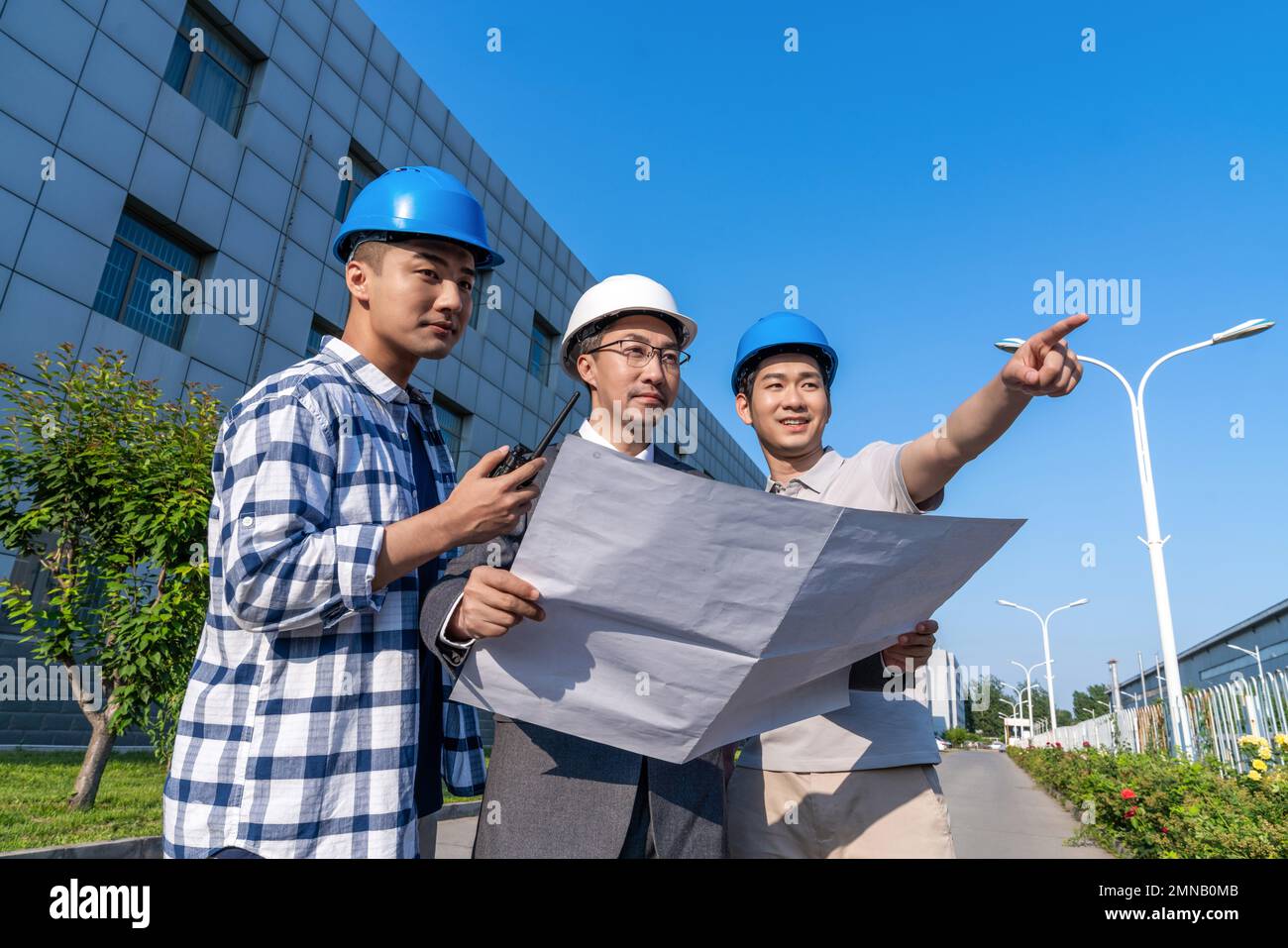 Three engineers working in the outdoor Stock Photo - Alamy