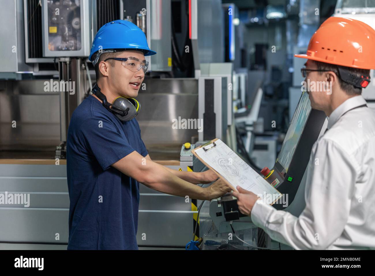 Two engineers working in the factory Stock Photo - Alamy