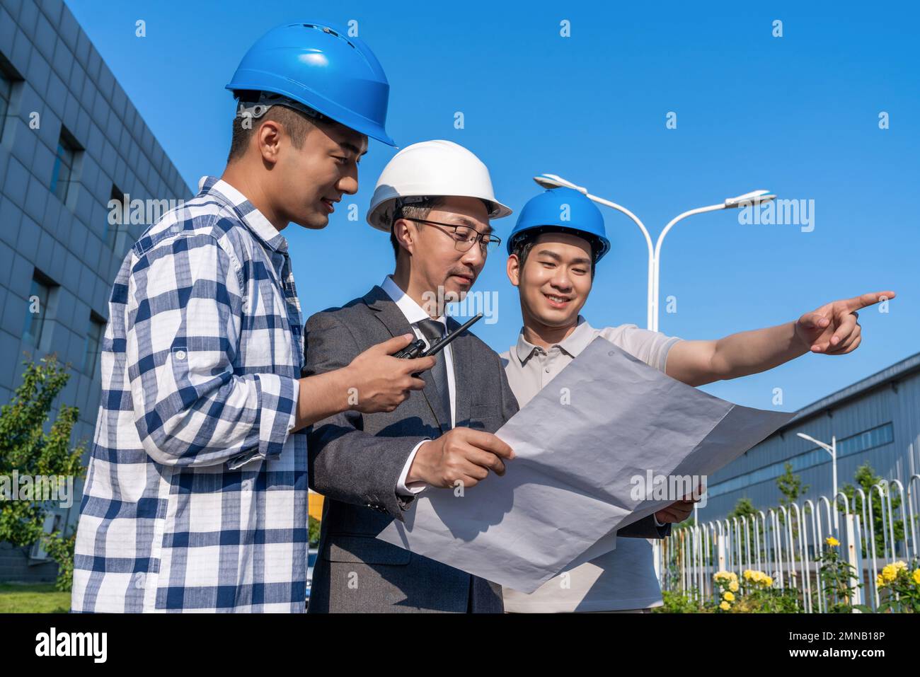 Three engineers working in the outdoor Stock Photo - Alamy