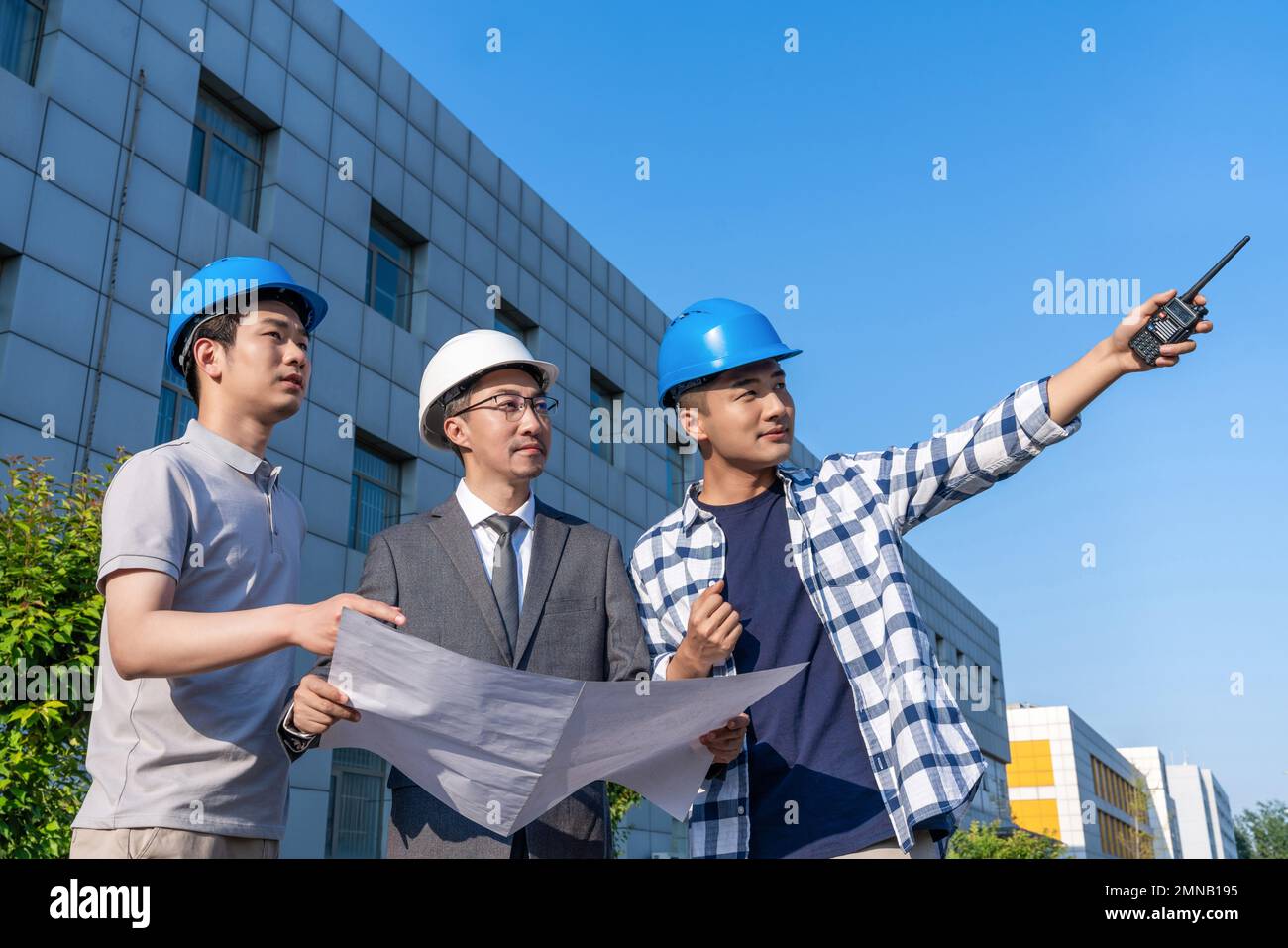 Three engineers working in the outdoor Stock Photo - Alamy