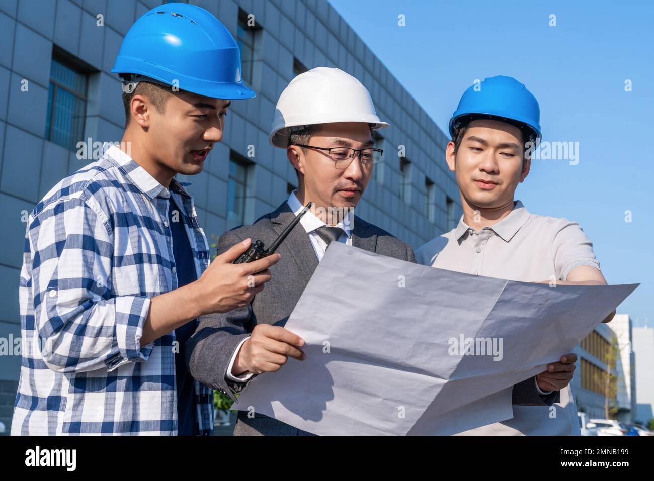 Three engineers working in the outdoor Stock Photo - Alamy