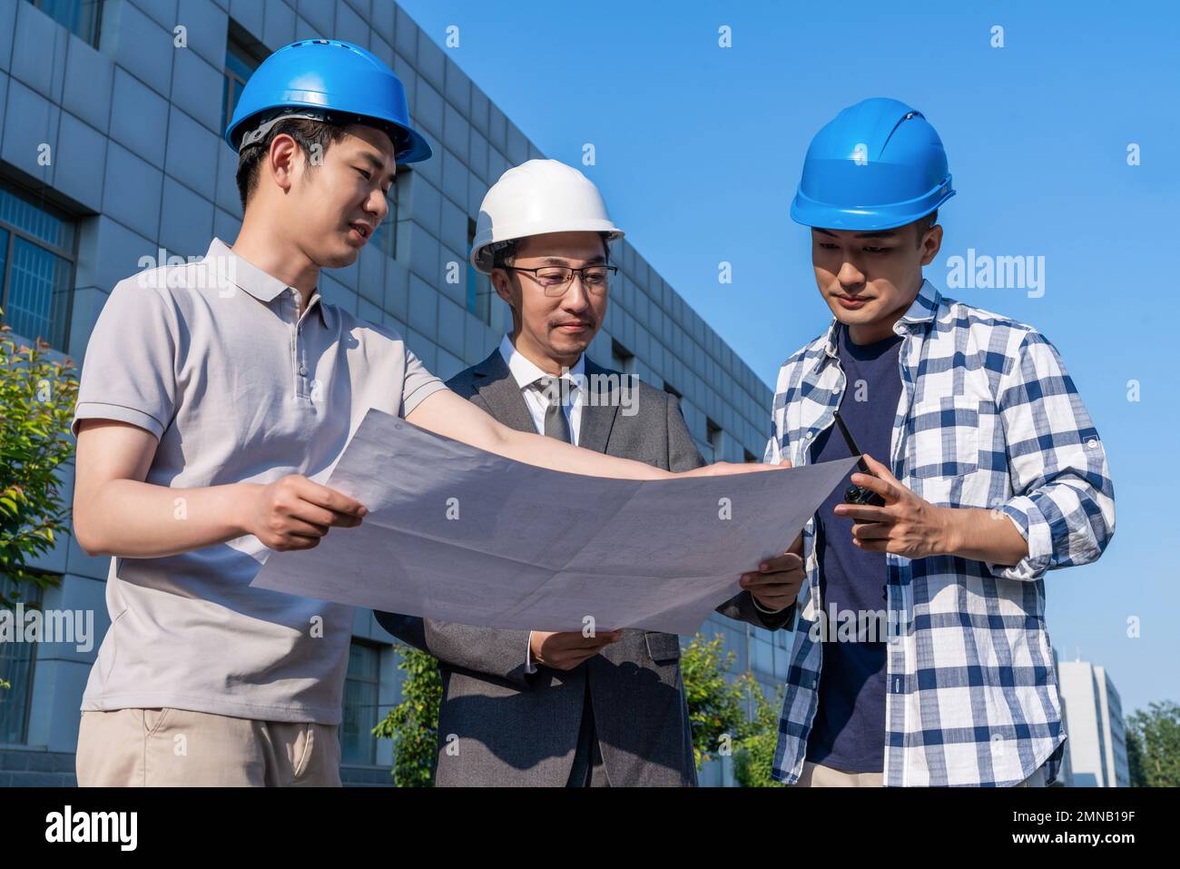 Three engineers working in the outdoor Stock Photo - Alamy