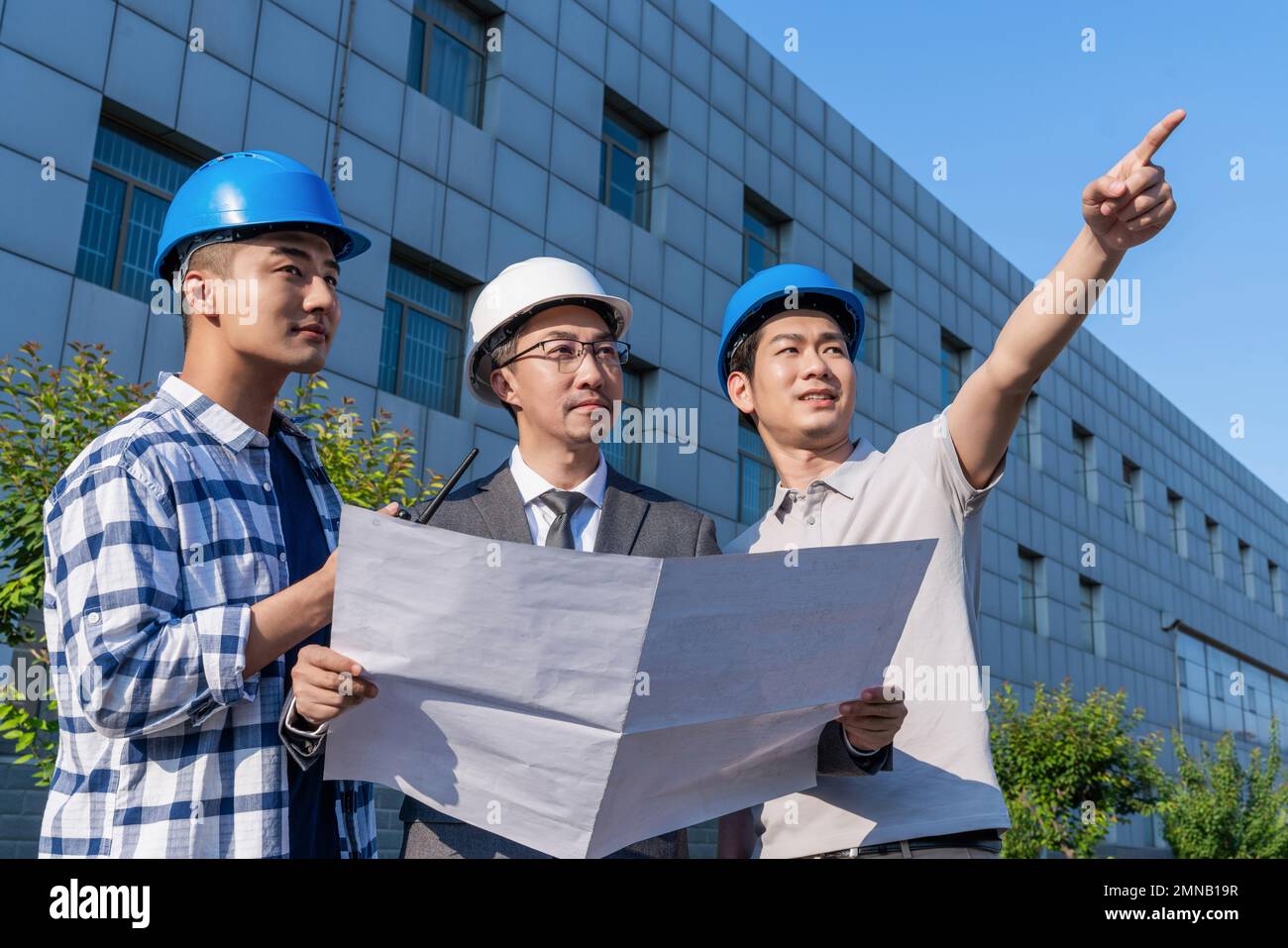 Three engineers working in the outdoor Stock Photo - Alamy