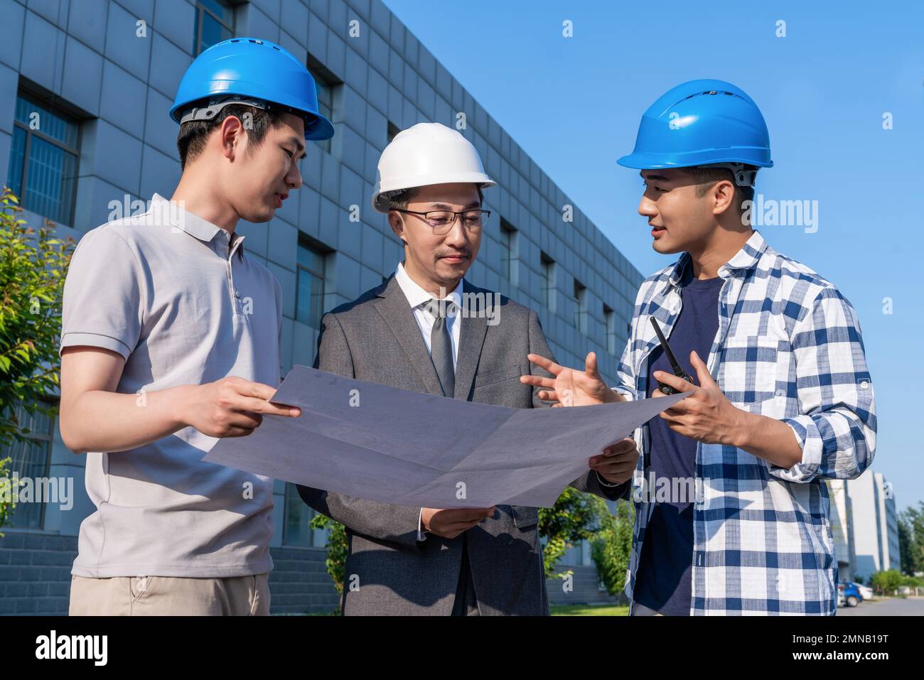 Three engineers working in the outdoor Stock Photo - Alamy