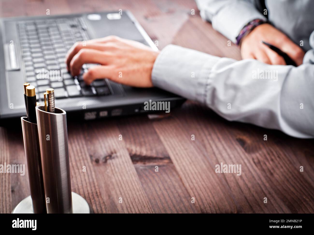 Man in shirt typing on the keyboard.Everyday scene of an employee at ...