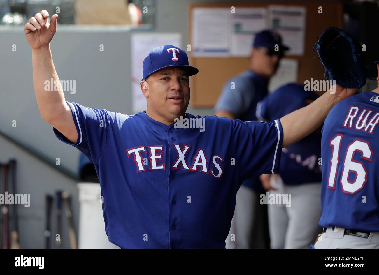 Texas Rangers starting pitcher Bartolo Colon walks in the dugout during ...
