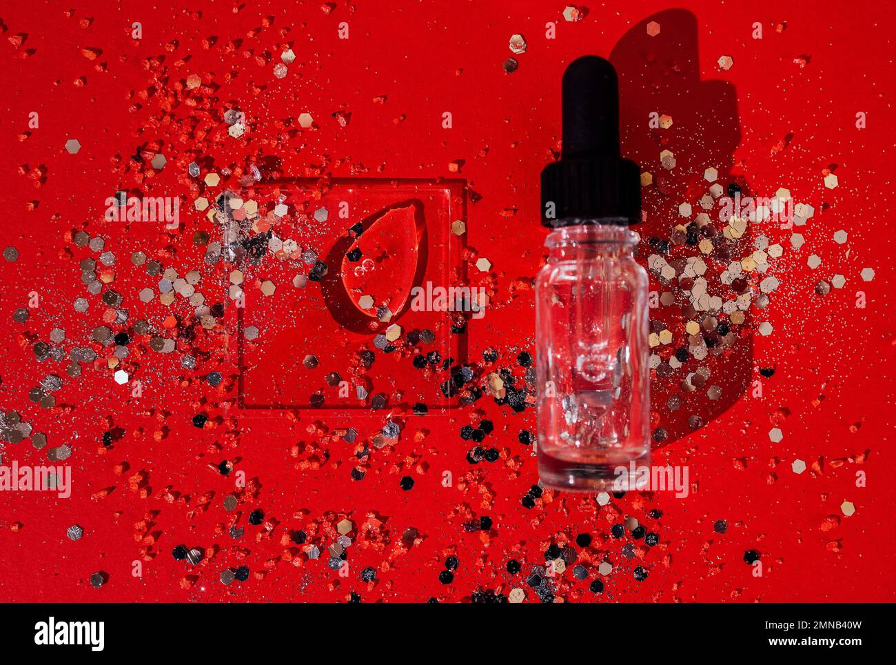 Transparent serum or oil glass bottle with pipette. Bright red ...