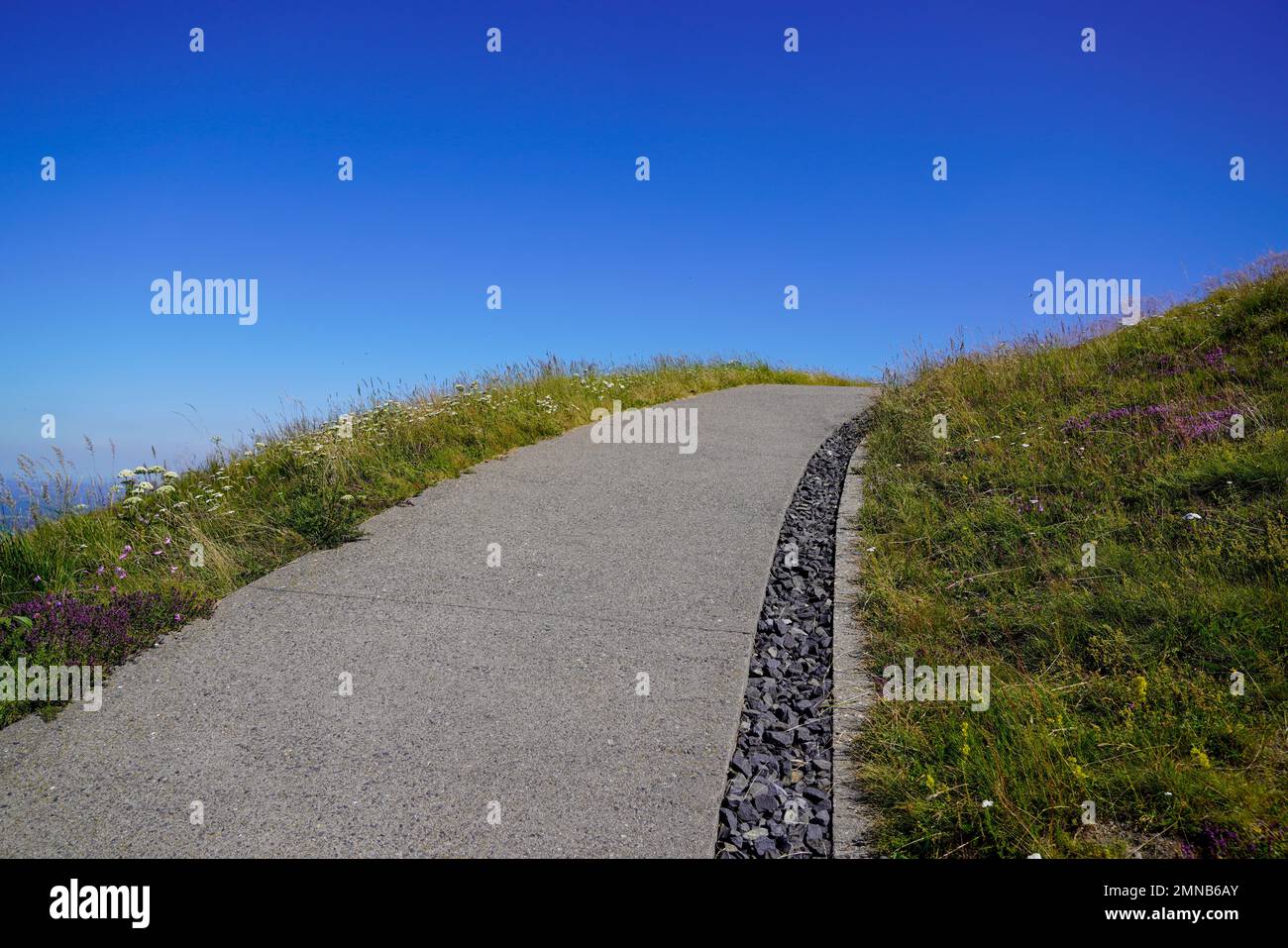 pedestrian path go up in the mountains horizon Stock Photo - Alamy