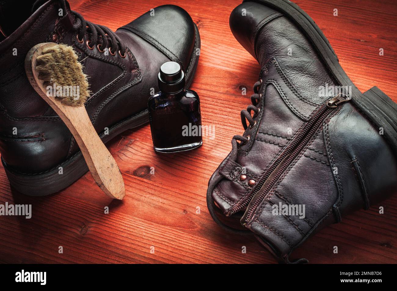 Concept of care and cleaning of vintage leather boots with wax, cream ...