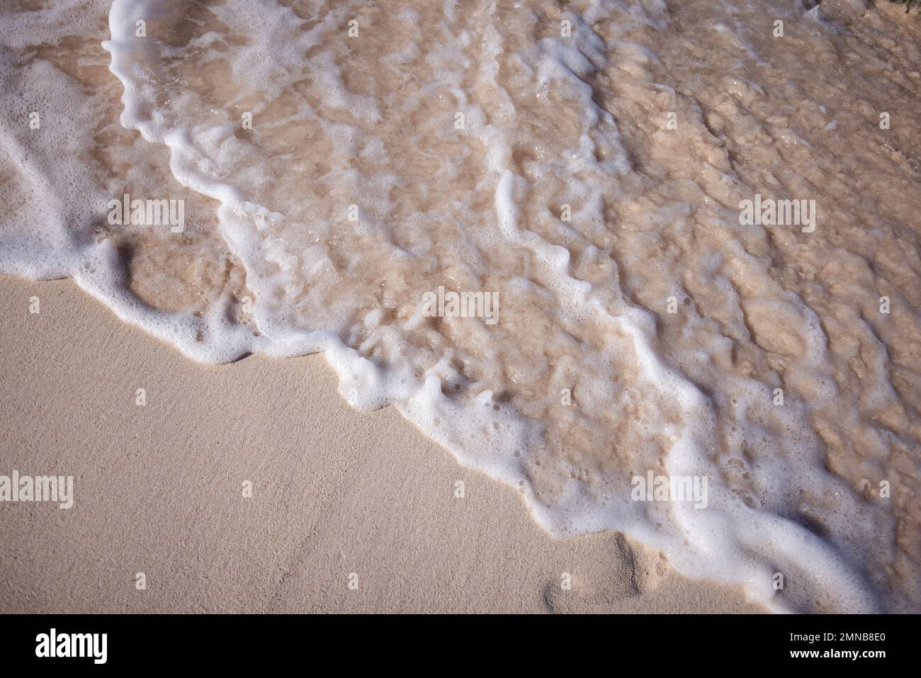 Gentle bubbles waves and sand on the beach texture background. Wave ...