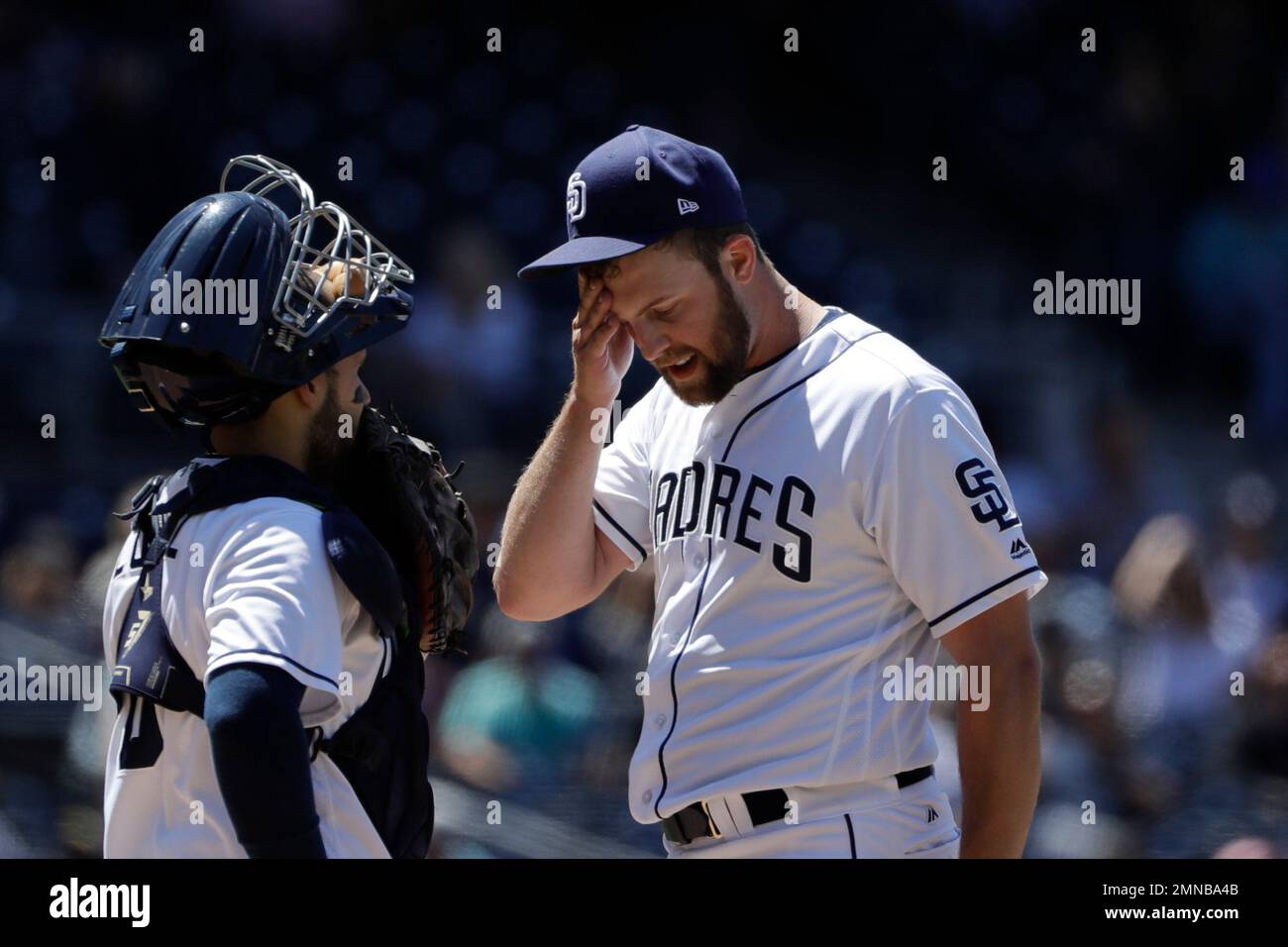 San Diego Padres starting pitcher Jordan Lyles, right, wipes his face ...