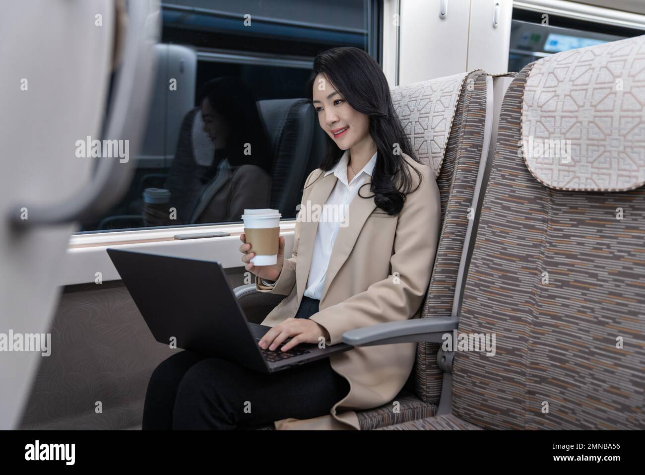 Business lady take the subway to use notebook computer Stock Photo - Alamy