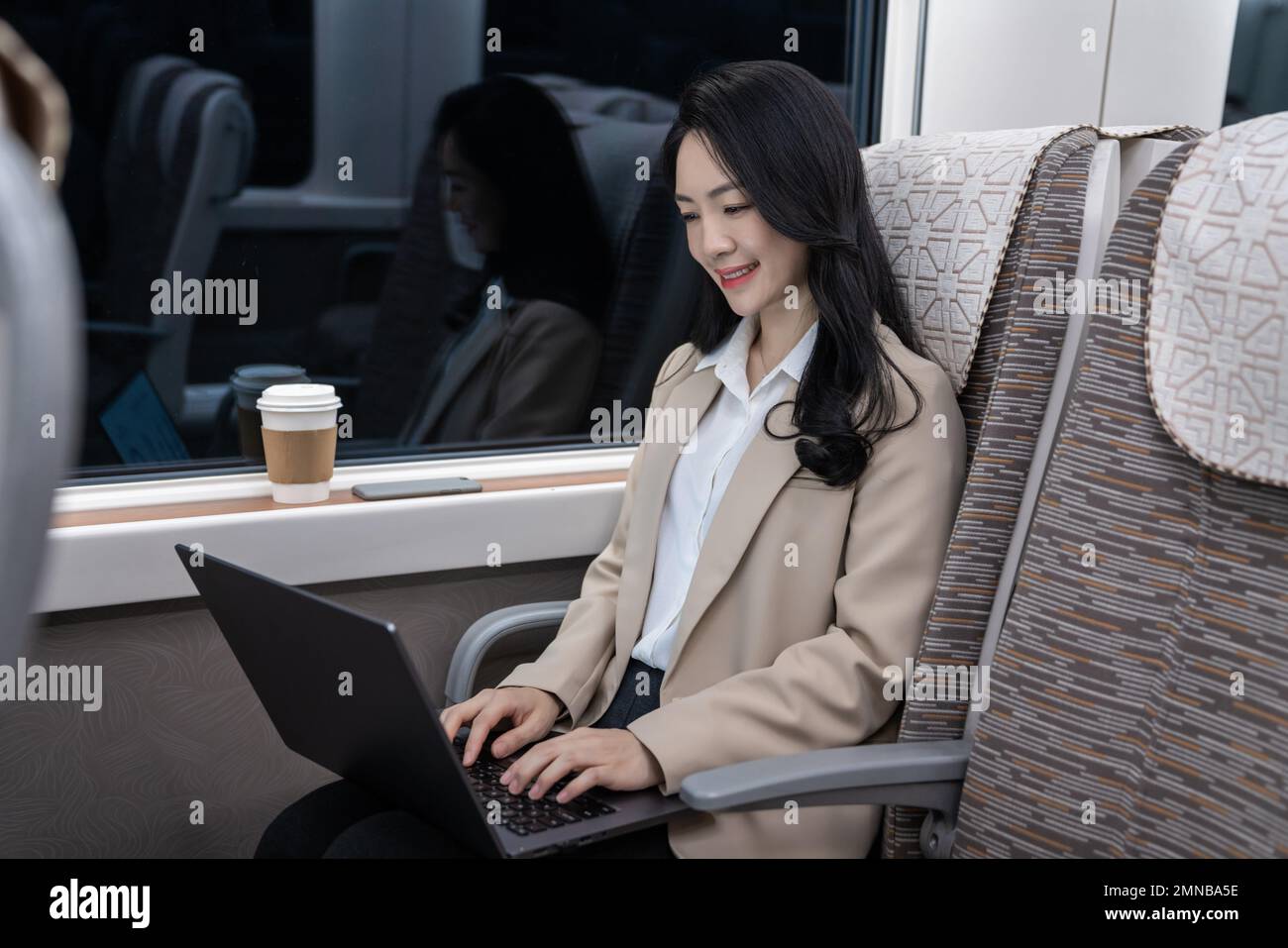 Business lady take the subway to use notebook computer Stock Photo - Alamy