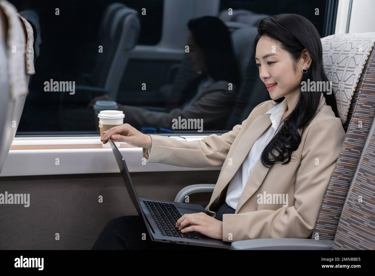 Business lady take the subway to use notebook computer Stock Photo - Alamy