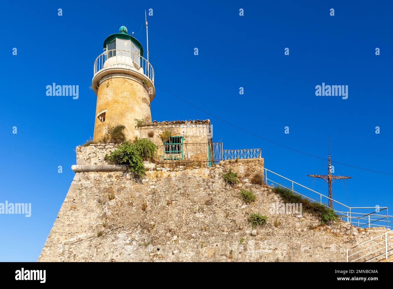 Lighthouse and cross on top of the old fortress, Kerkyra, Corfu Stock ...