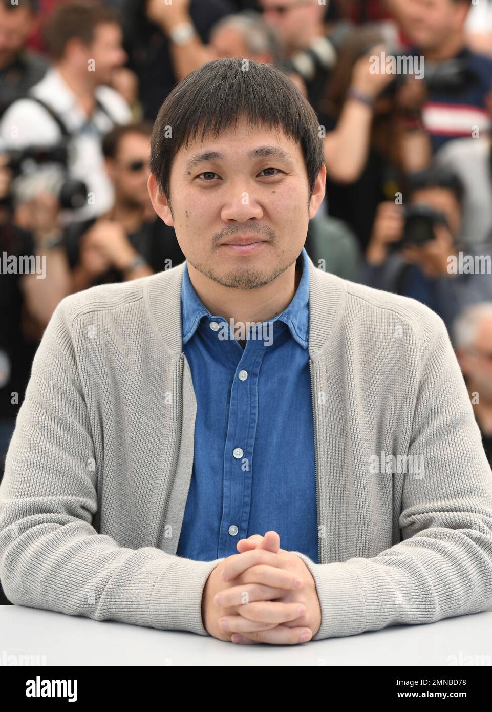 Director Ryusuke Hamaguchi poses for photographers during a photo call ...