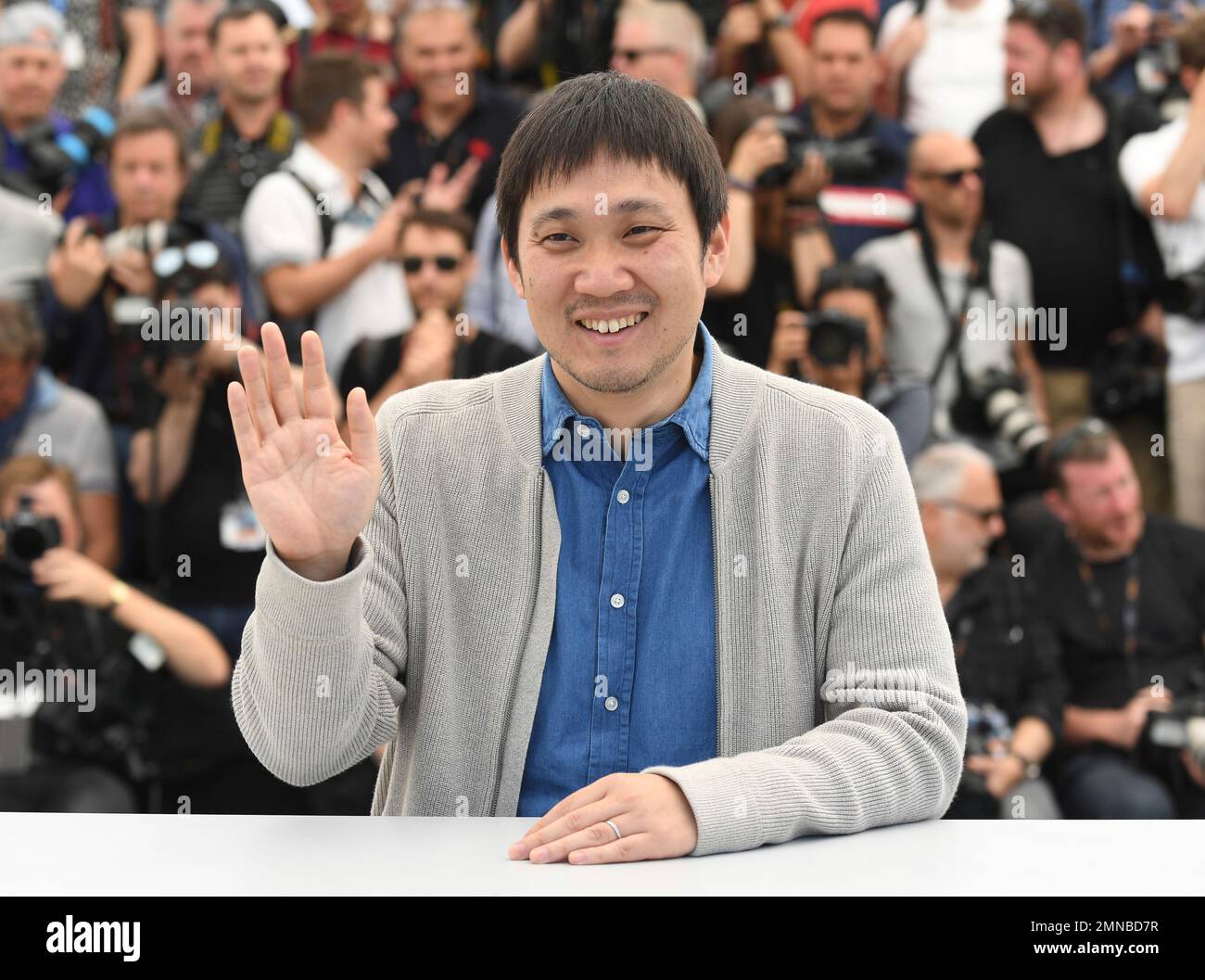 Director Ryusuke Hamaguchi poses for photographers during a photo call ...