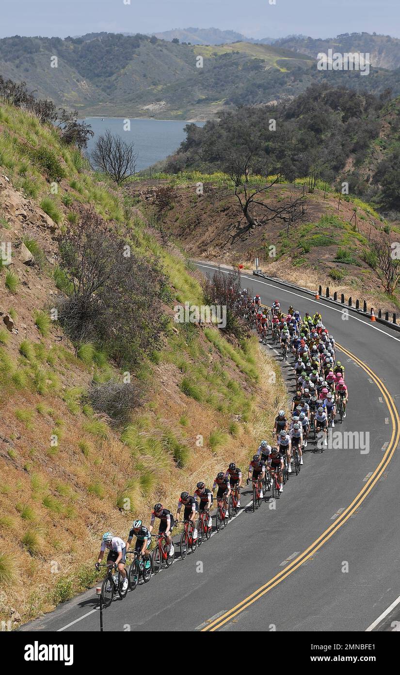 The peloton rides near Lake Casitias during Stage 2 of the AMGEN Tour ...