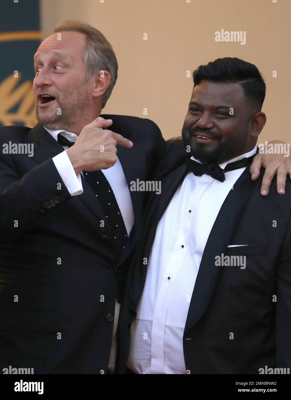 Actors Benoit Poelvoorde, left, and Balasingham Thamilchelvan pose for photographers upon ...