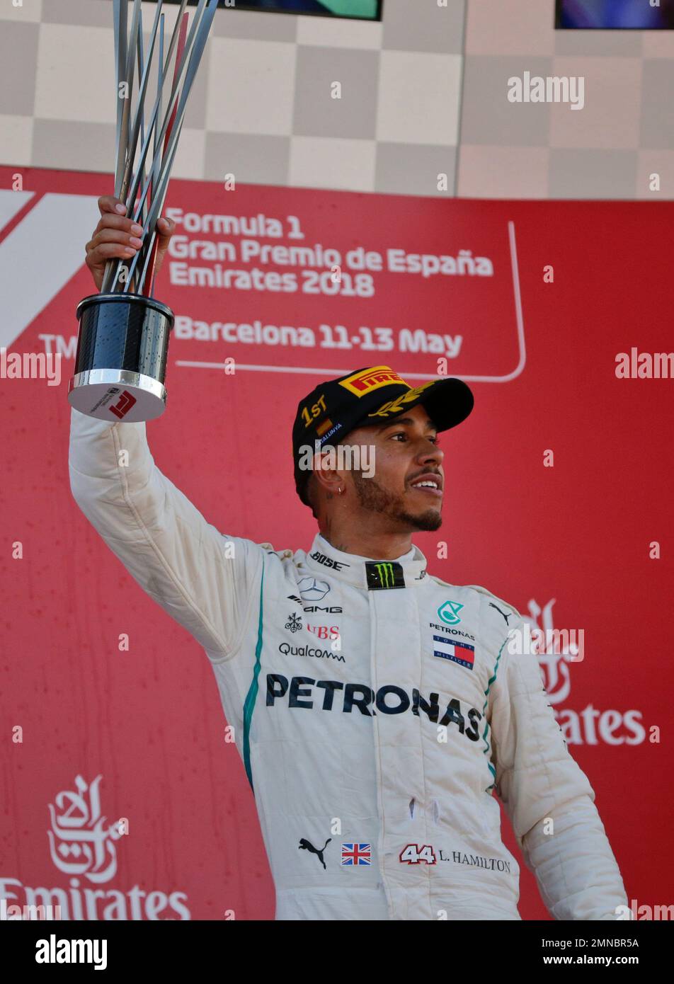 Mercedes driver Lewis Hamilton of Britain holds the trophy on the ...