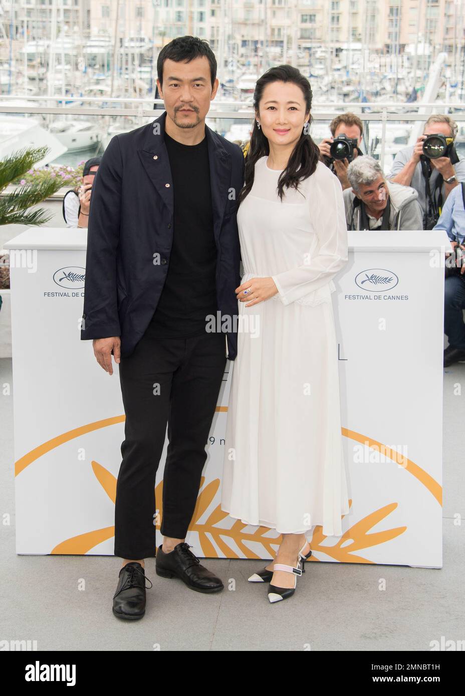 Actors Liao Fan, left, and Zhao Tao pose for photographers during a ...