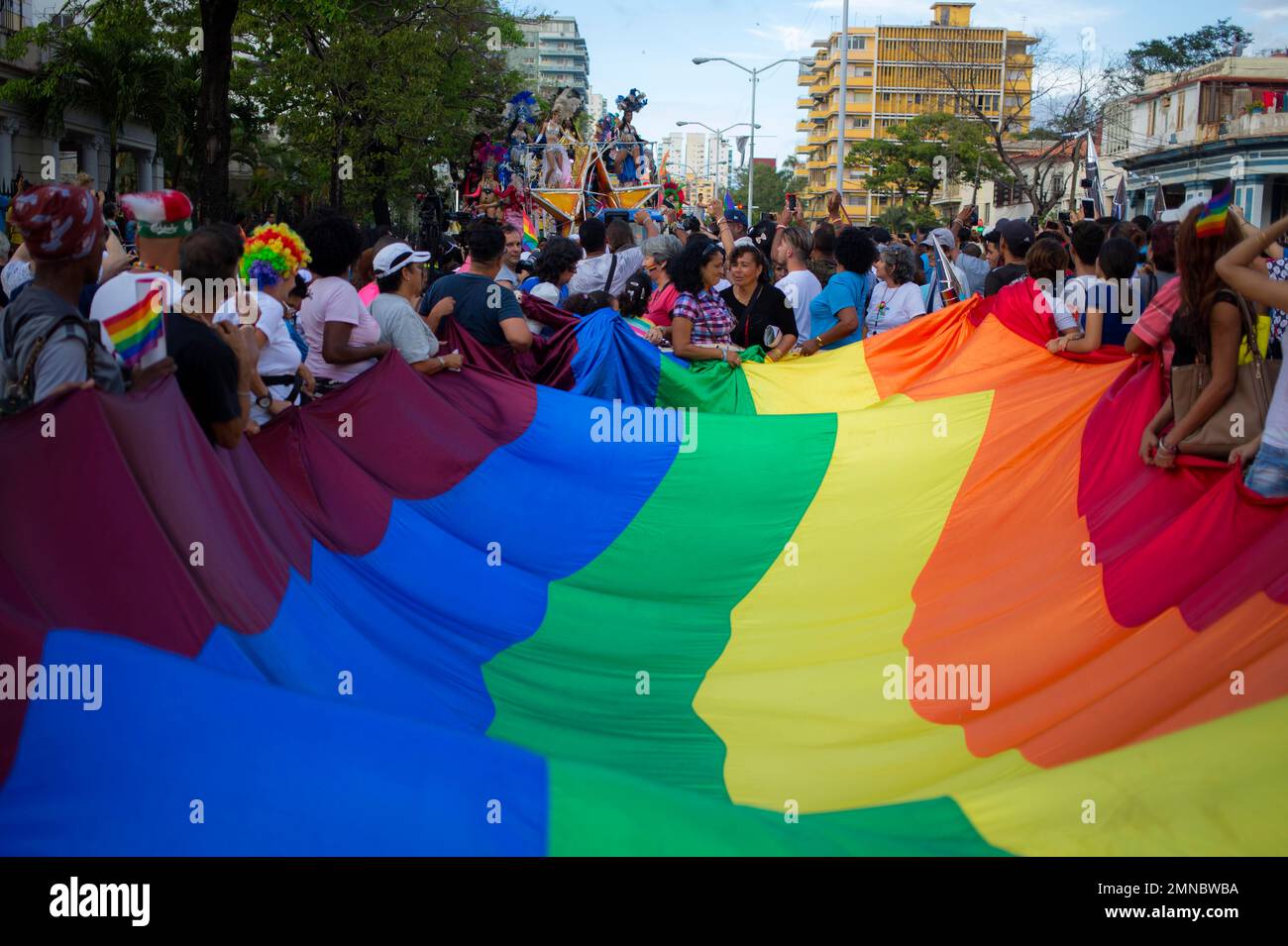 People carry a giant pride flag during the annual LGBT Parade in Havana ...