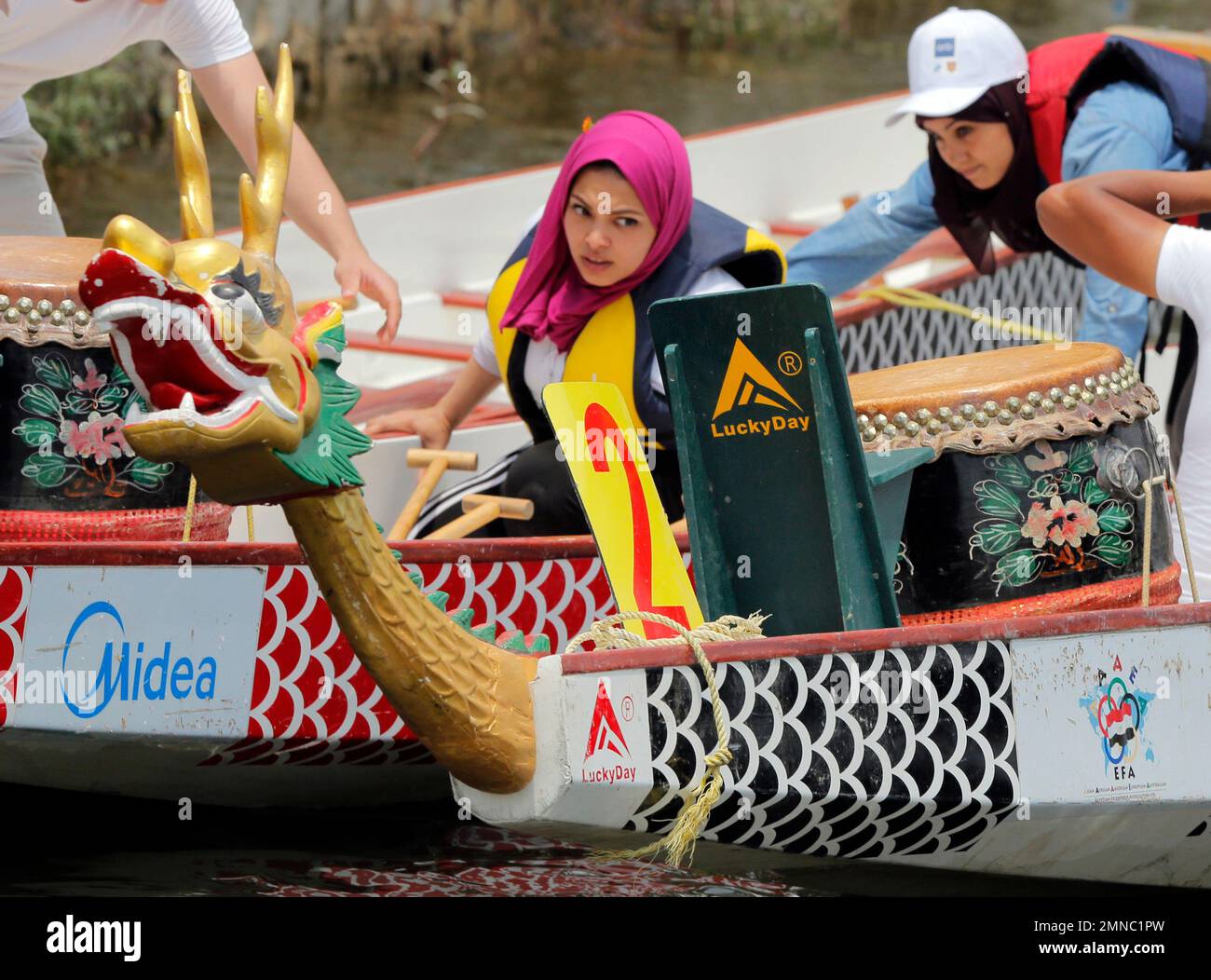 Chinese and Egyptian rowing teams prepare to race on their dragon boats ...