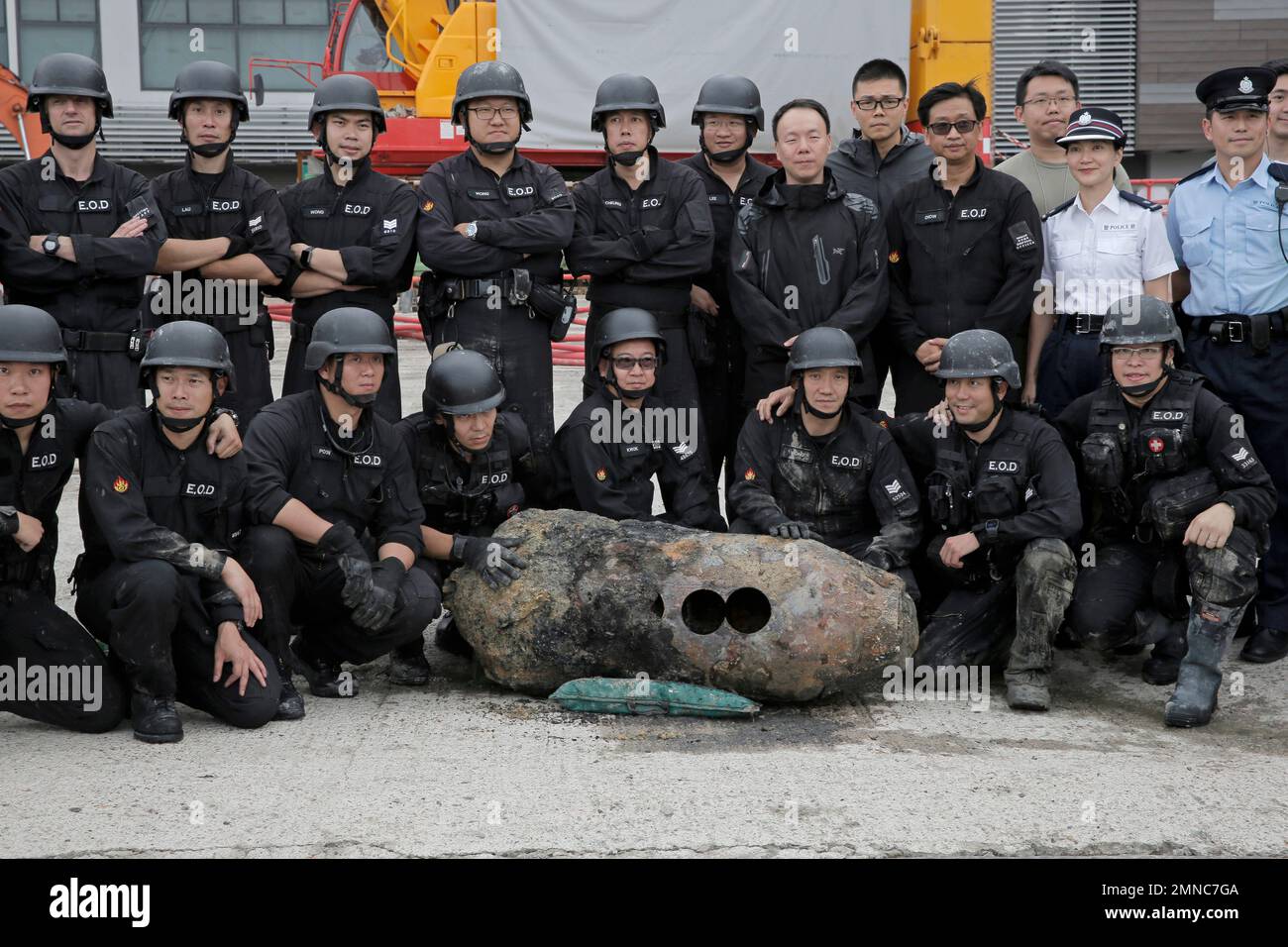 Police bomb squad pose a deactivated bomb to a truck at the scene in ...