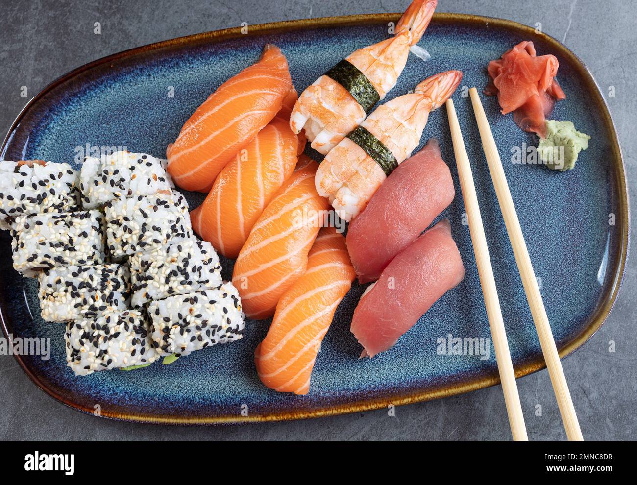 Top view of classic sushi rolls with salmon nigiris, wasabi, ginger and ...
