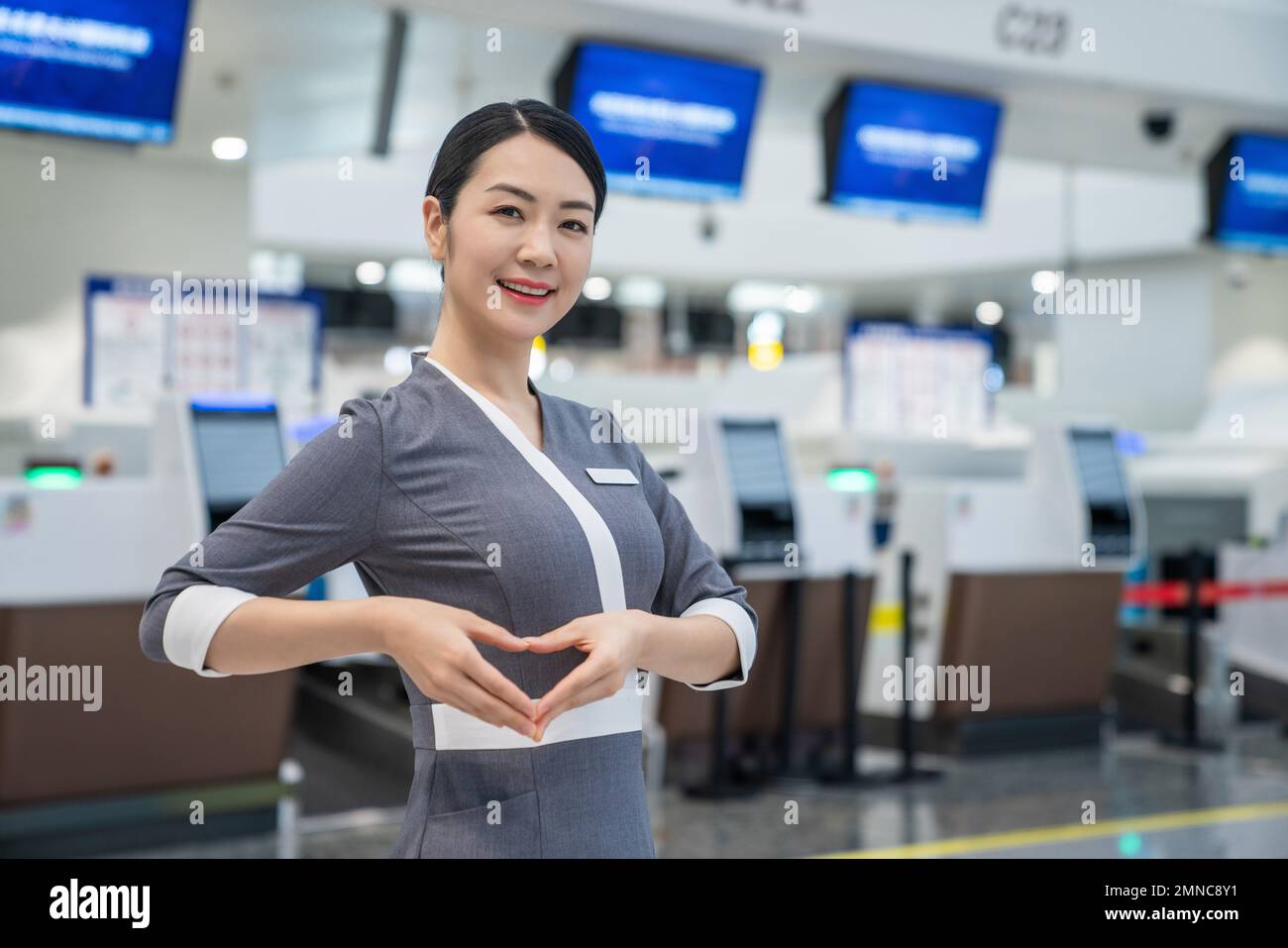 Smile of a flight attendant Stock Photo - Alamy