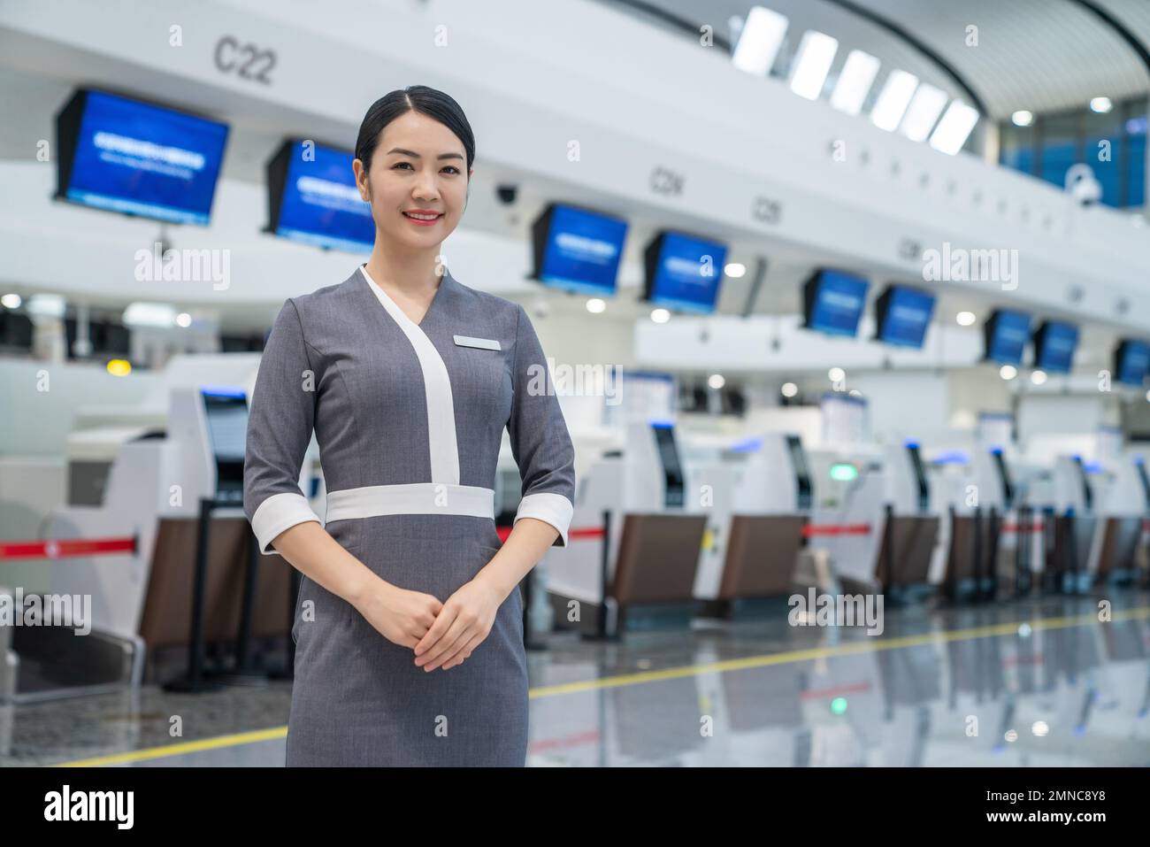 Smile of a flight attendant Stock Photo - Alamy