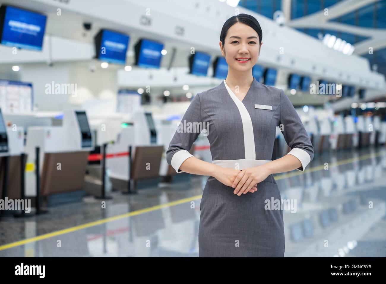Smile of a flight attendant Stock Photo - Alamy