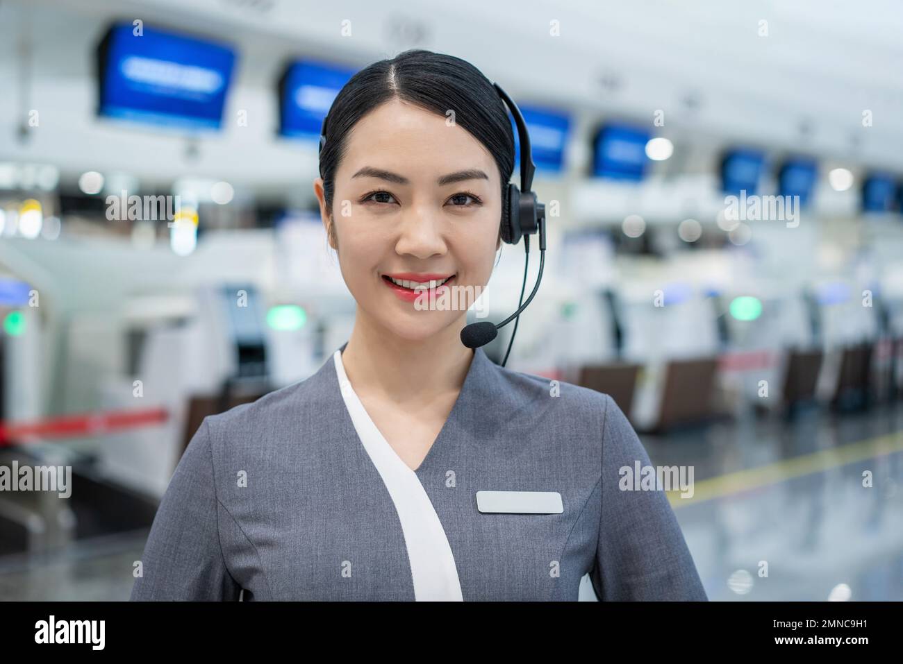 The smile of a flight attendant wearing headphones Stock Photo - Alamy