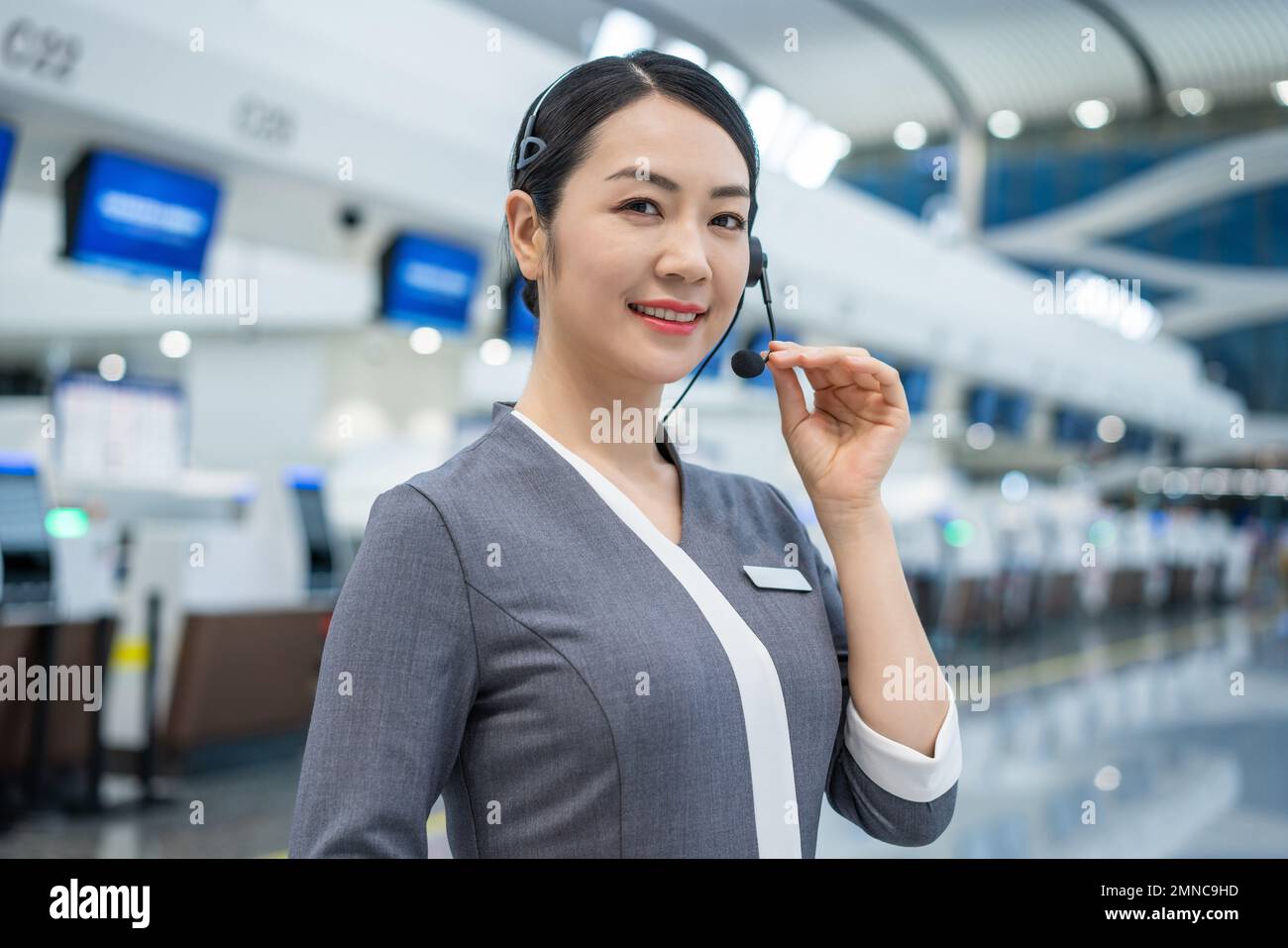The smile of a flight attendant wearing headphones Stock Photo - Alamy