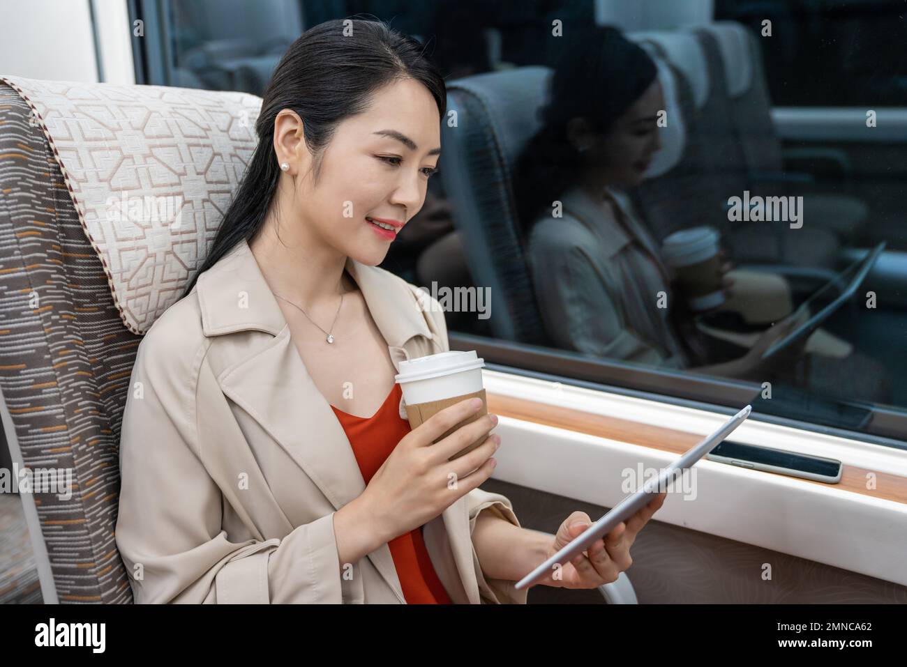 Business lady take the subway to use tablet Stock Photo - Alamy