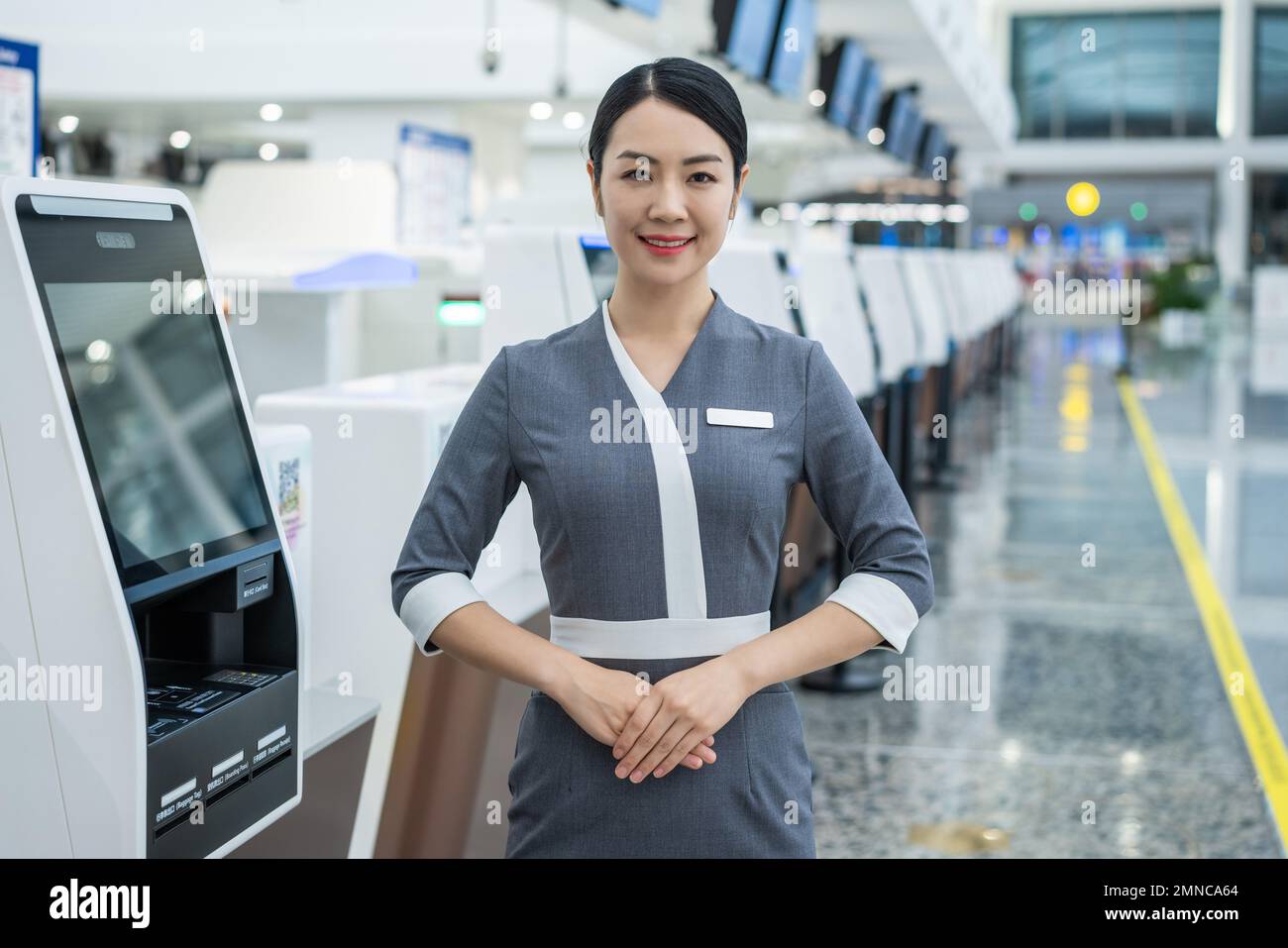 Smile of a flight attendant demonstration self-service check-in Stock ...