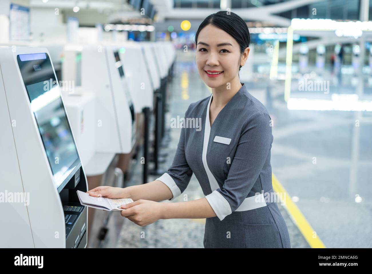 Smile of a flight attendant demonstration self-service check-in Stock ...