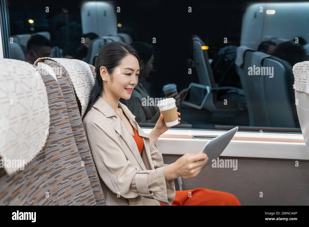 Business lady take the subway to use tablet Stock Photo - Alamy