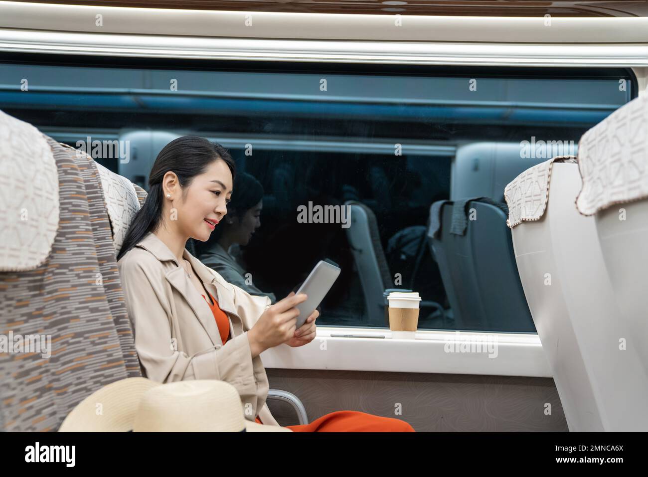 Business lady take the subway to use tablet Stock Photo - Alamy