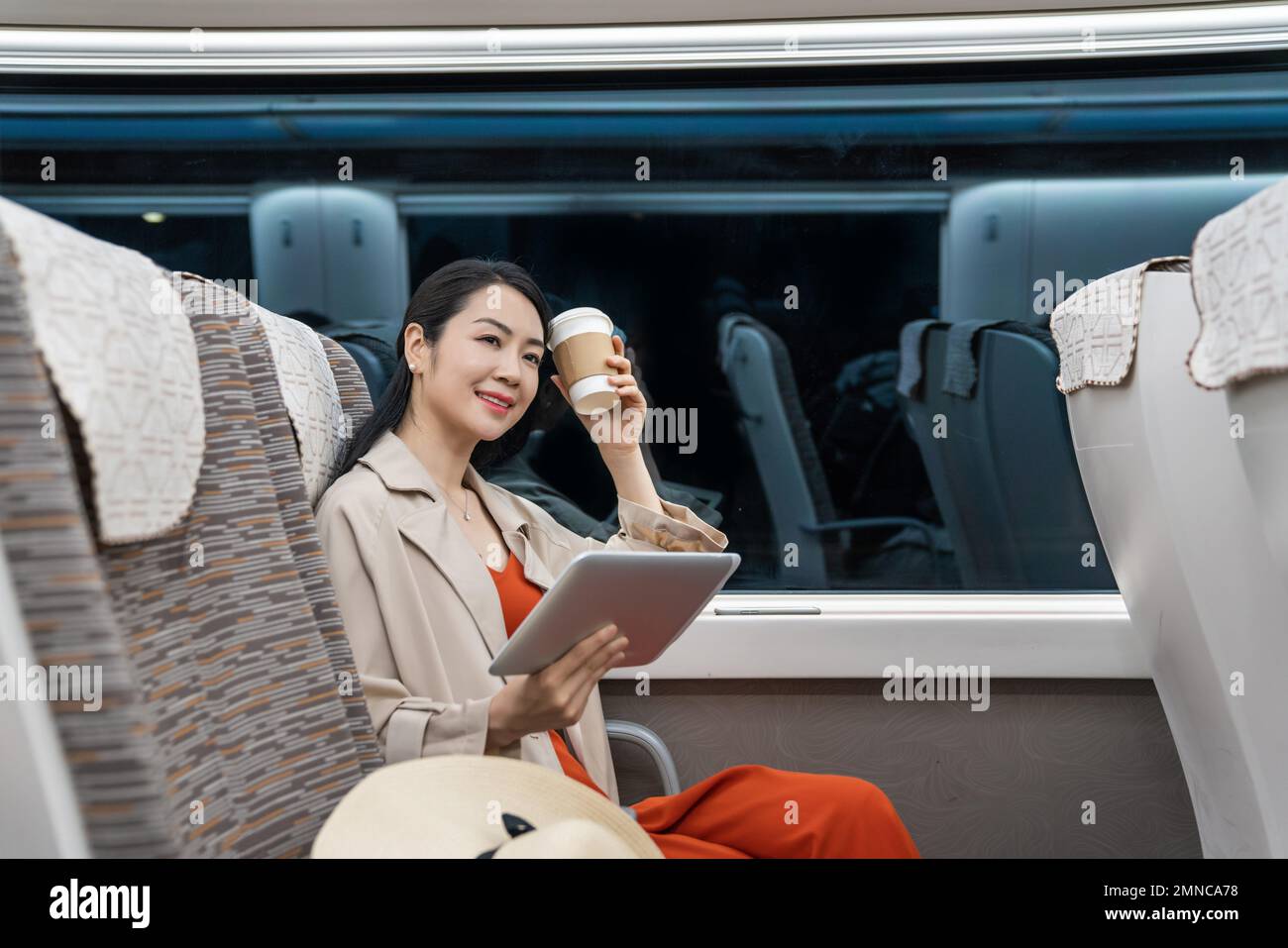 Business lady take the subway to use tablet Stock Photo - Alamy