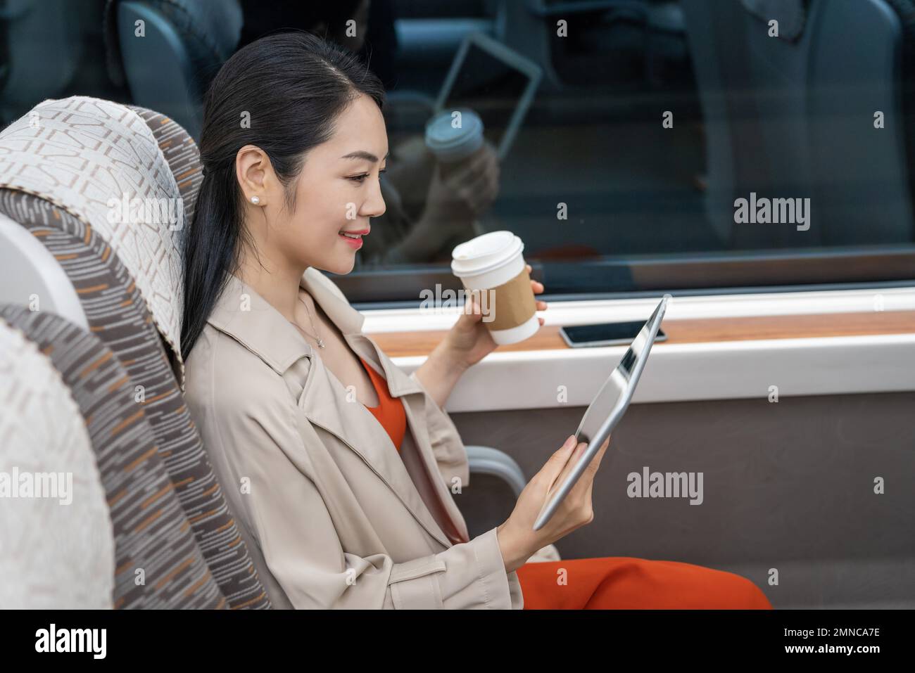 Business lady take the subway to use tablet Stock Photo - Alamy