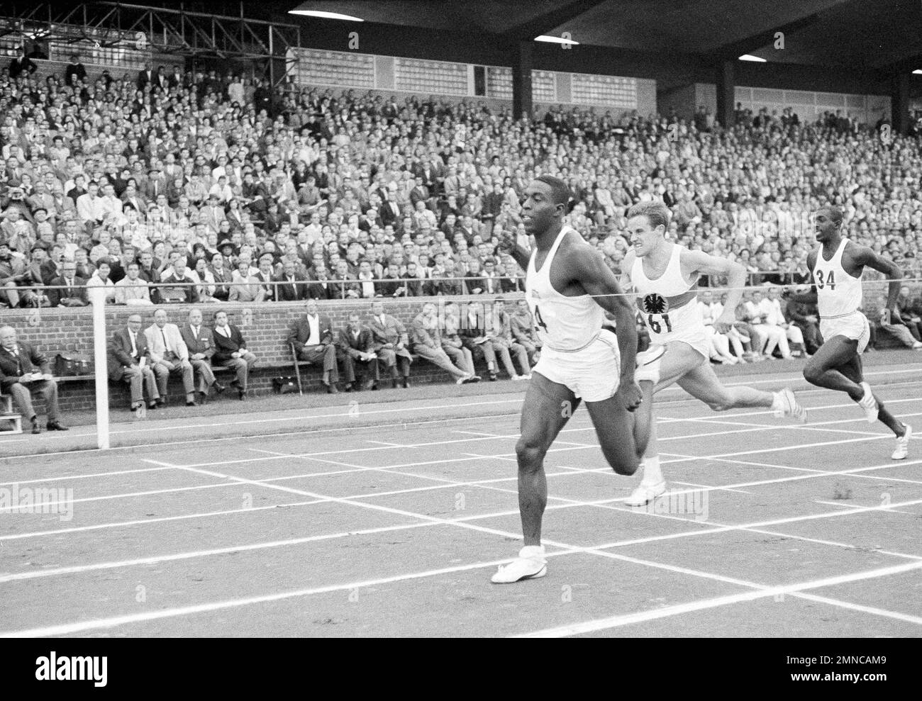 Bob Hayes, foreground, of Jacksonville, Fla., crosses the finish line ...