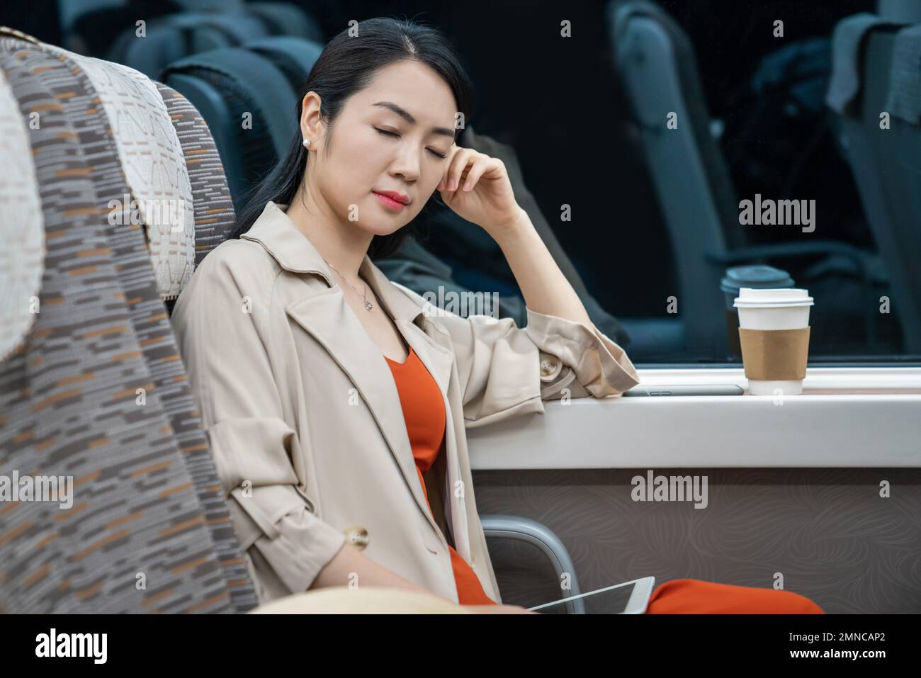 Business lady take the subway to use tablet Stock Photo - Alamy