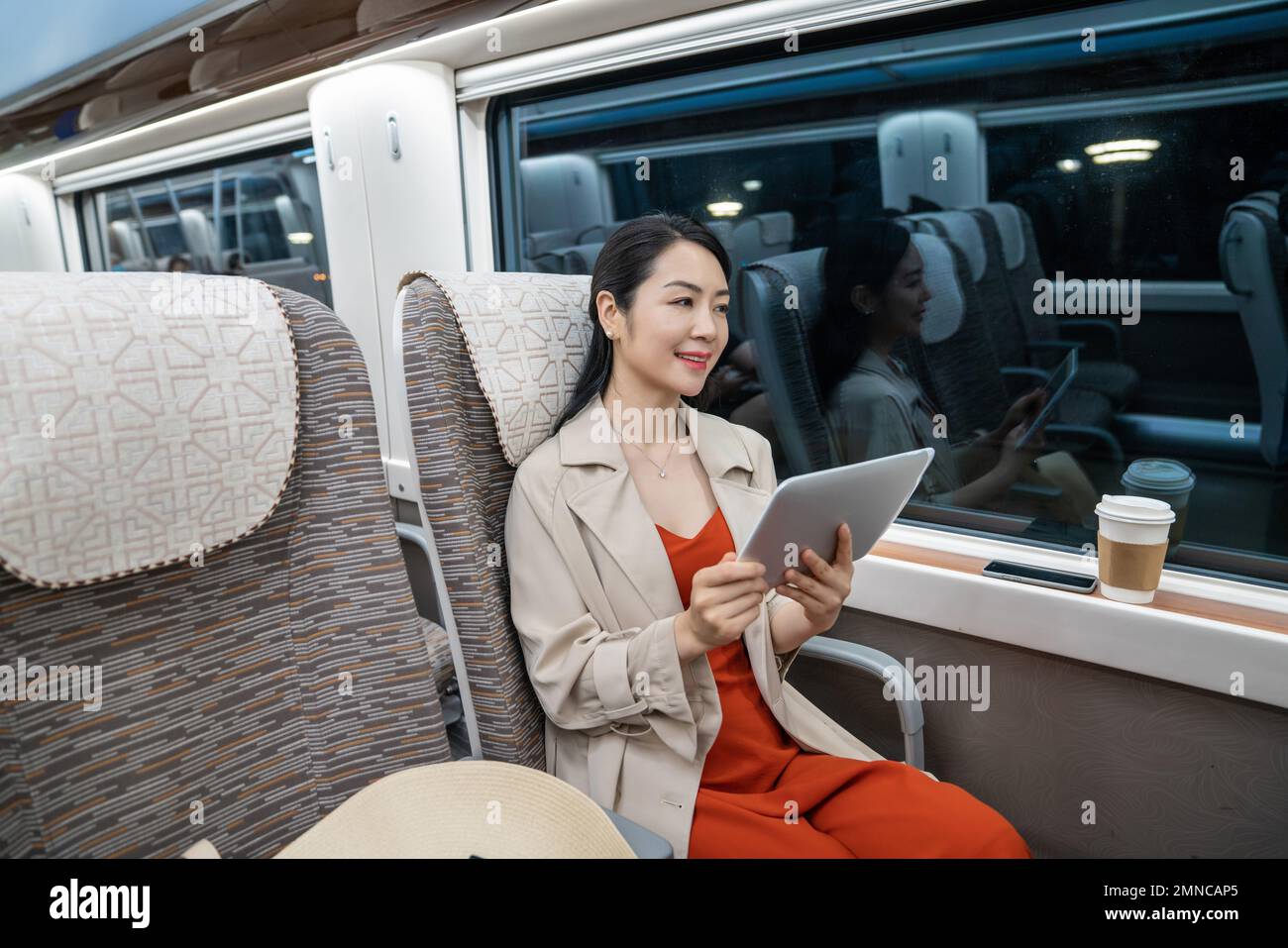 Business lady take the subway to use tablet Stock Photo - Alamy