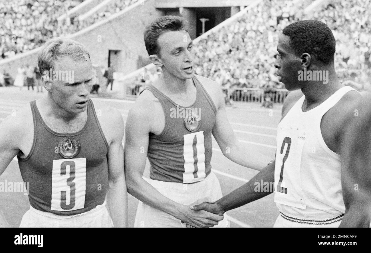 Robert Hayes of the U.S., right, is congratulated by two rivals after ...