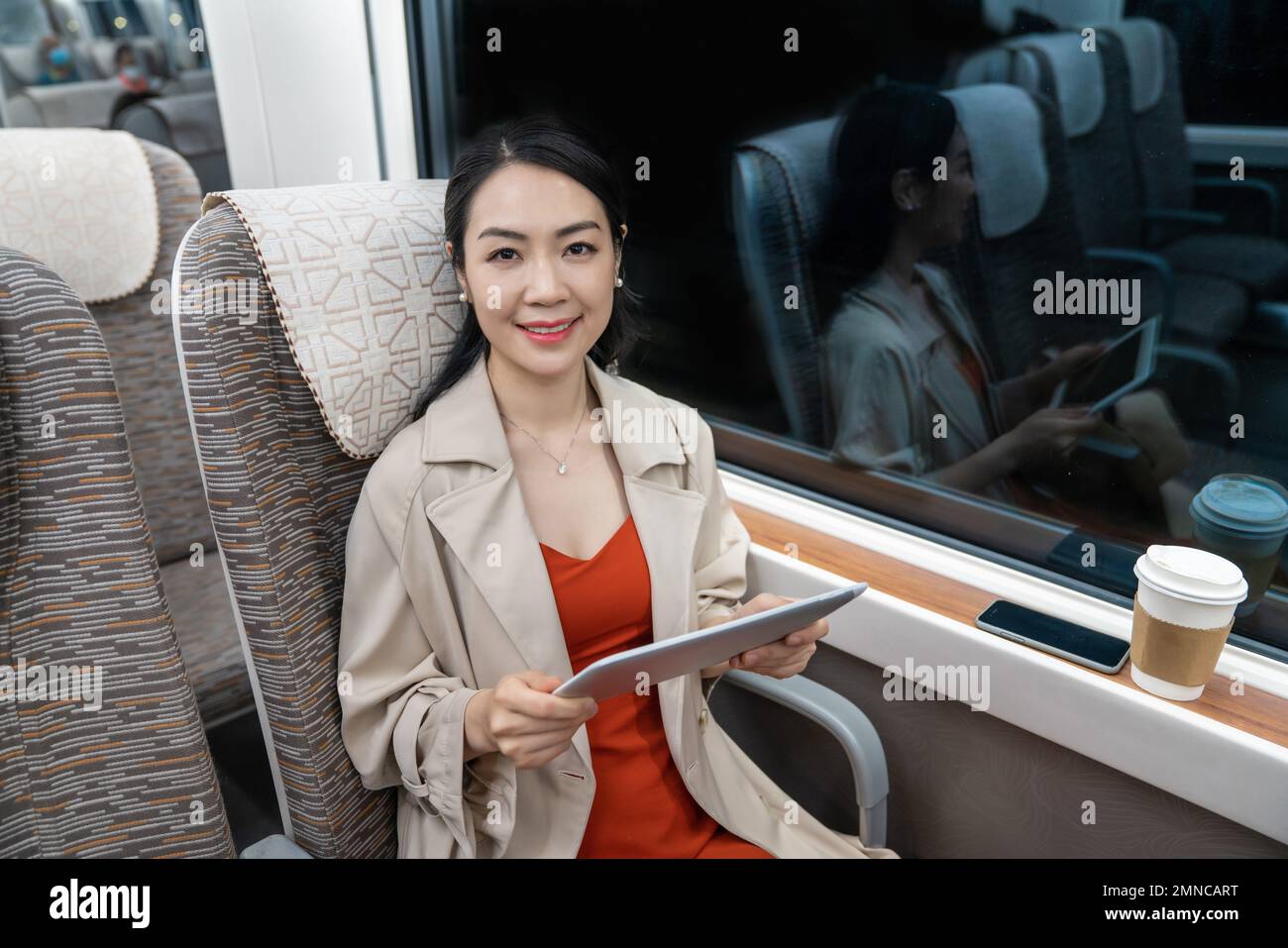 Business lady take the subway to use tablet Stock Photo - Alamy