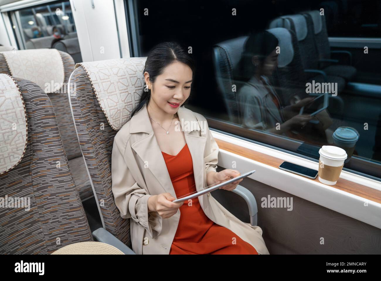 Business lady take the subway to use tablet Stock Photo - Alamy