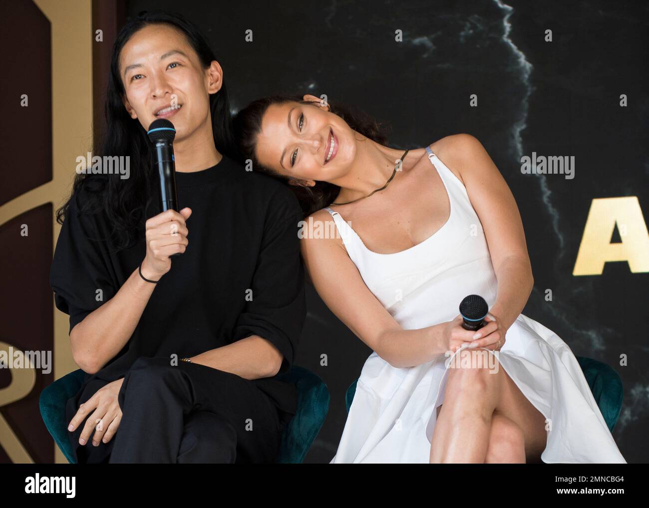 Designer Alexander Wang, left, and model Bella Hadid speak during a ...